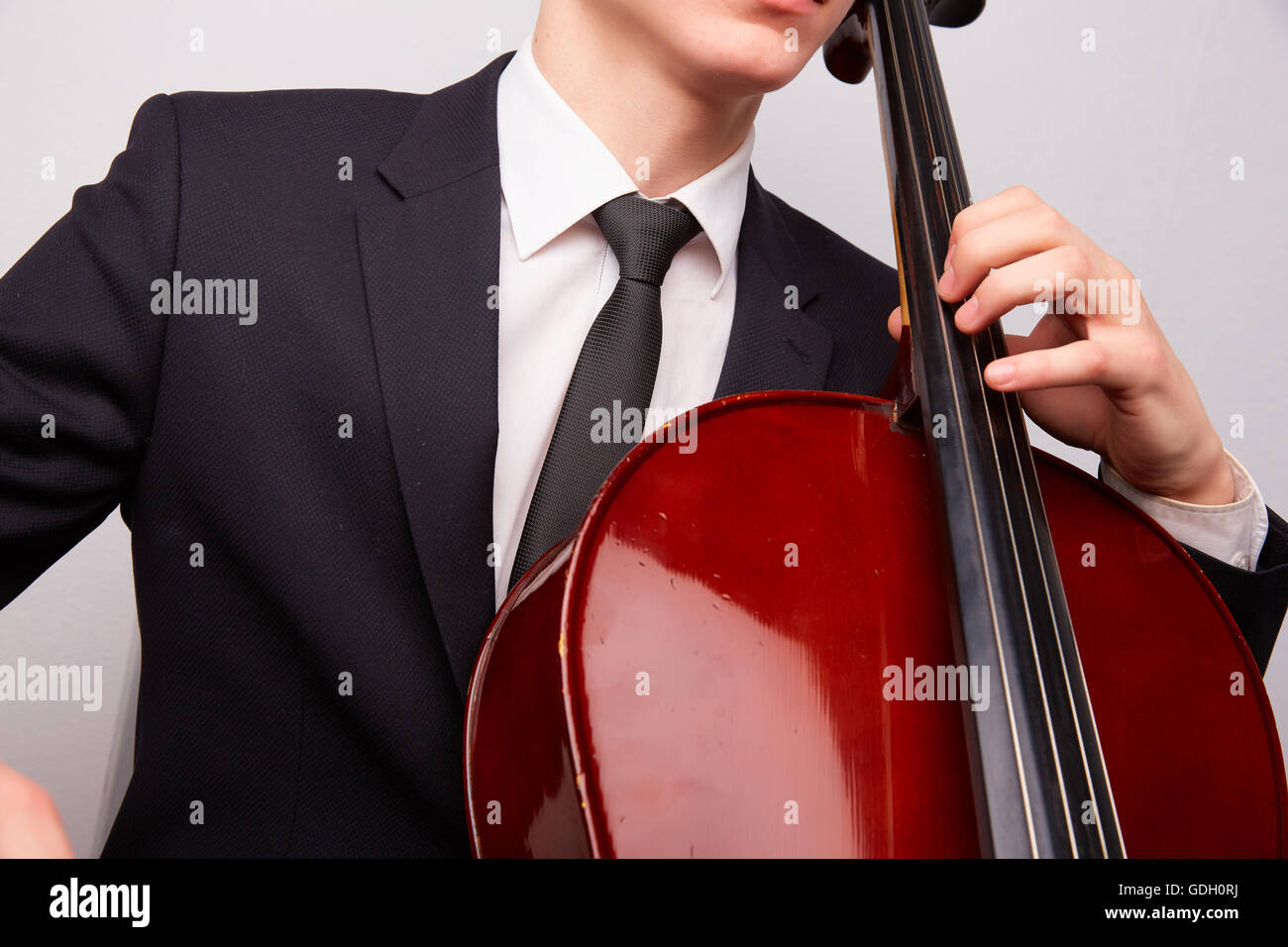young man with a cello Stock Photo - Alamy