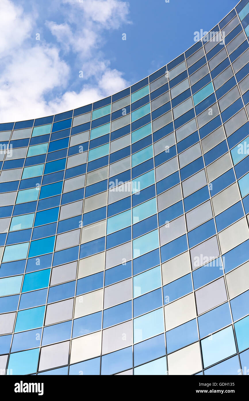 Modern glass city building against cloudy sky Stock Photo - Alamy
