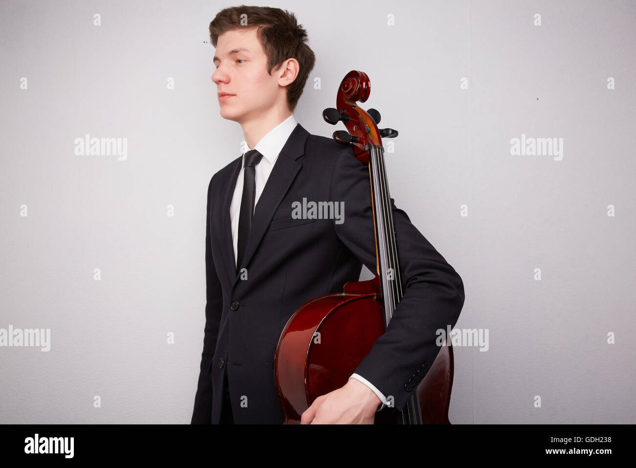 young man with a cello Stock Photo - Alamy