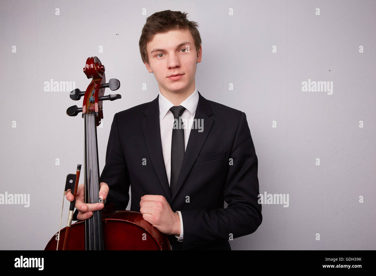 young man with a cello Stock Photo - Alamy