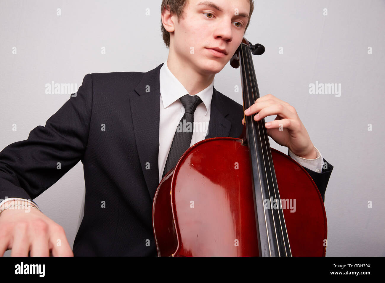young man with a cello Stock Photo - Alamy