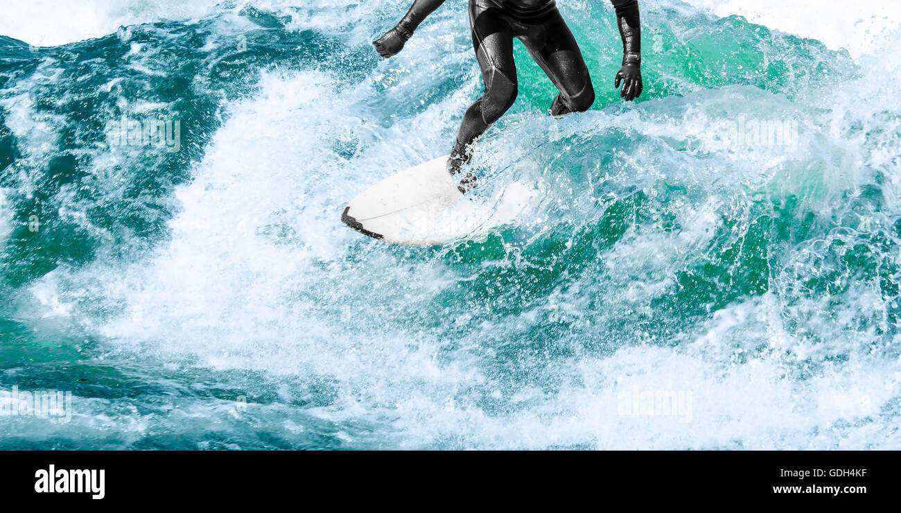 Surfing on turquoise ocean wave with close-up water splashes Stock ...