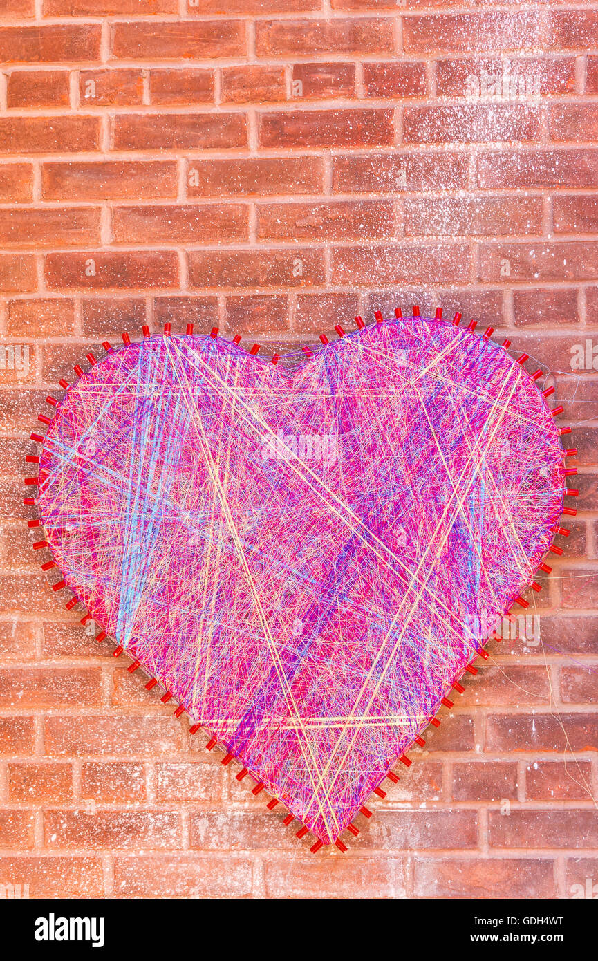 Woven heart on a wall Stock Photo - Alamy