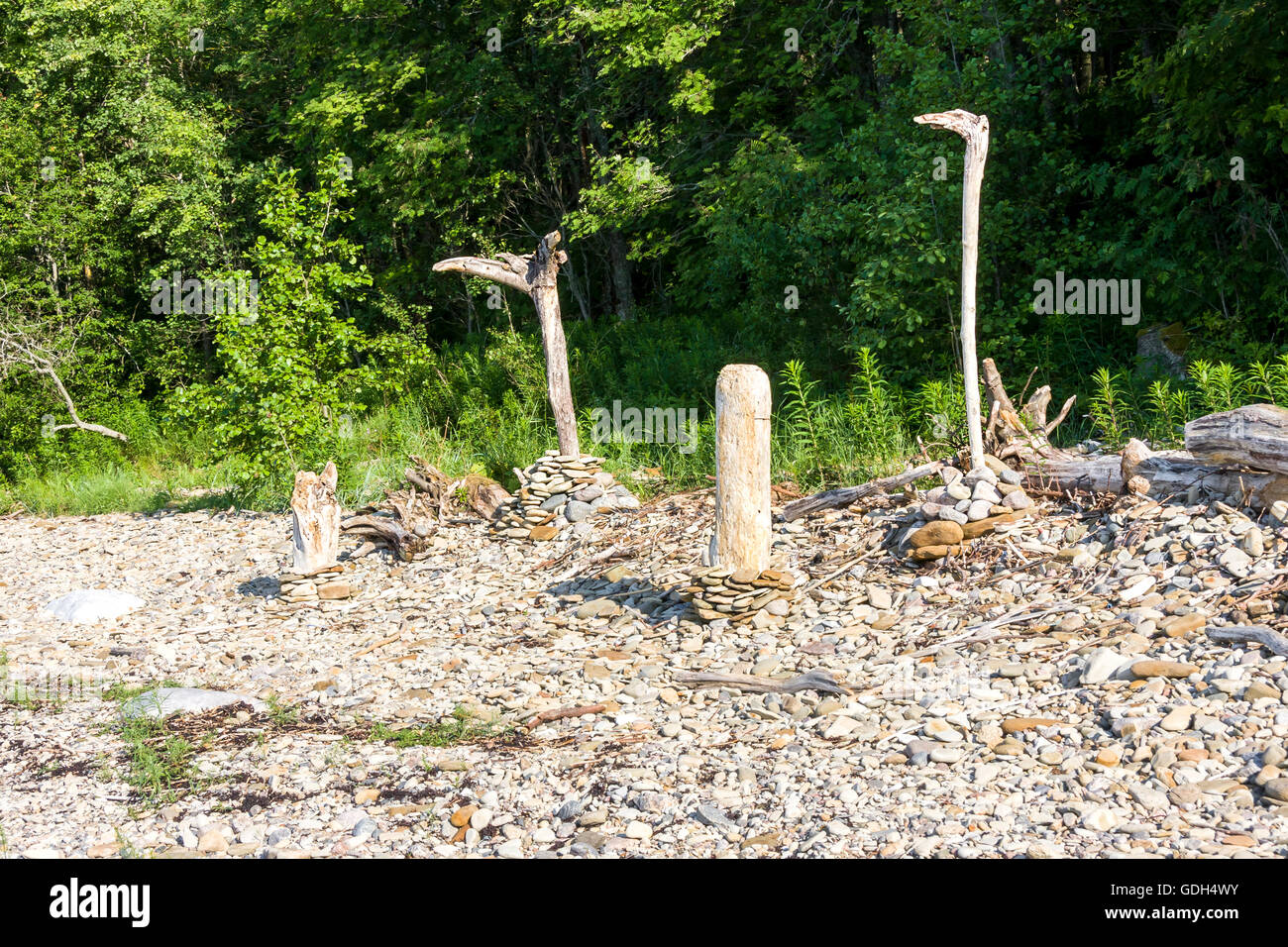 Old peeled tree stems placed on cobble stones Stock Photo - Alamy