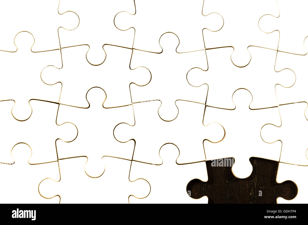 white jigsaw/puzzle wite one gap over black wooden table background ...