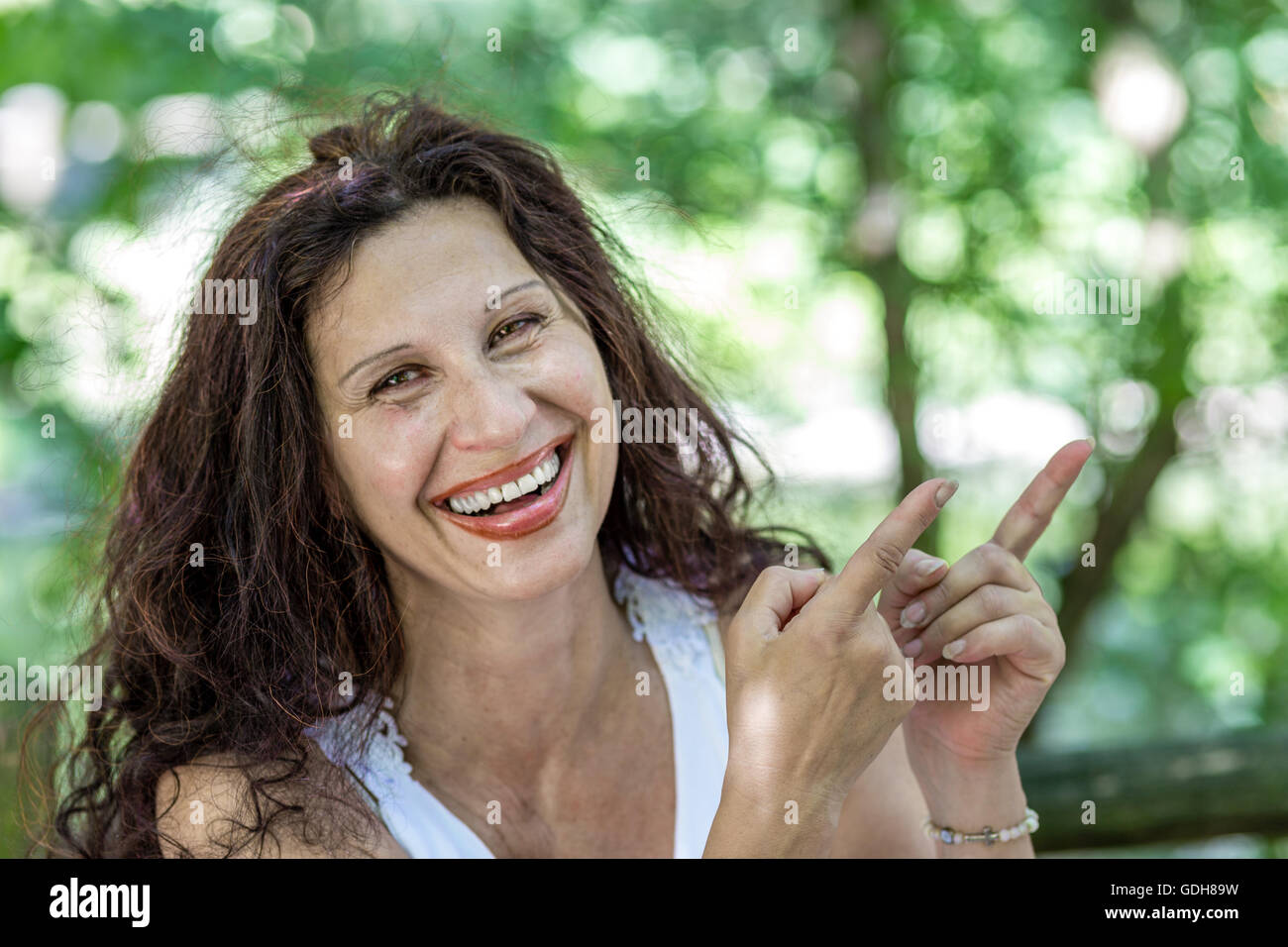 happy attractive woman pointing fingers away Stock Photo - Alamy