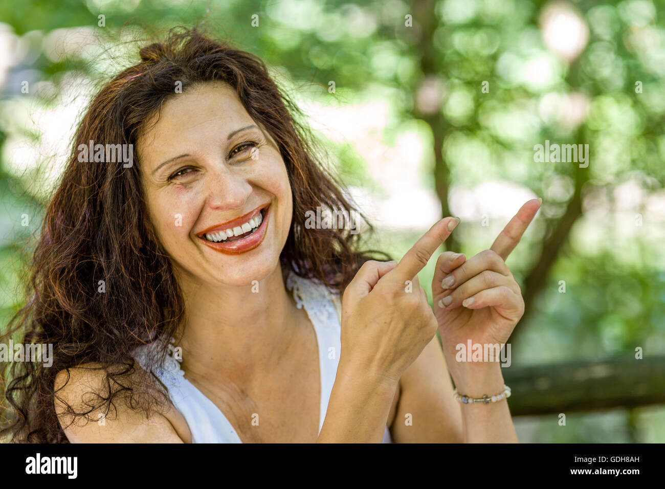 happy attractive woman pointing to the side with both hands Stock Photo ...