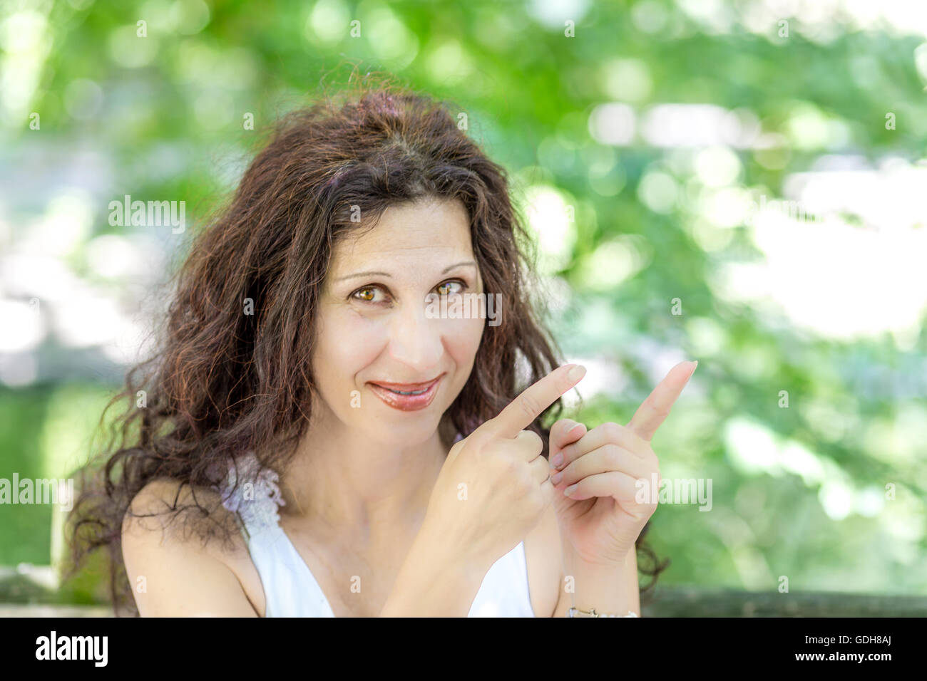 happy attractive woman pointing to the side with both hands Stock Photo ...