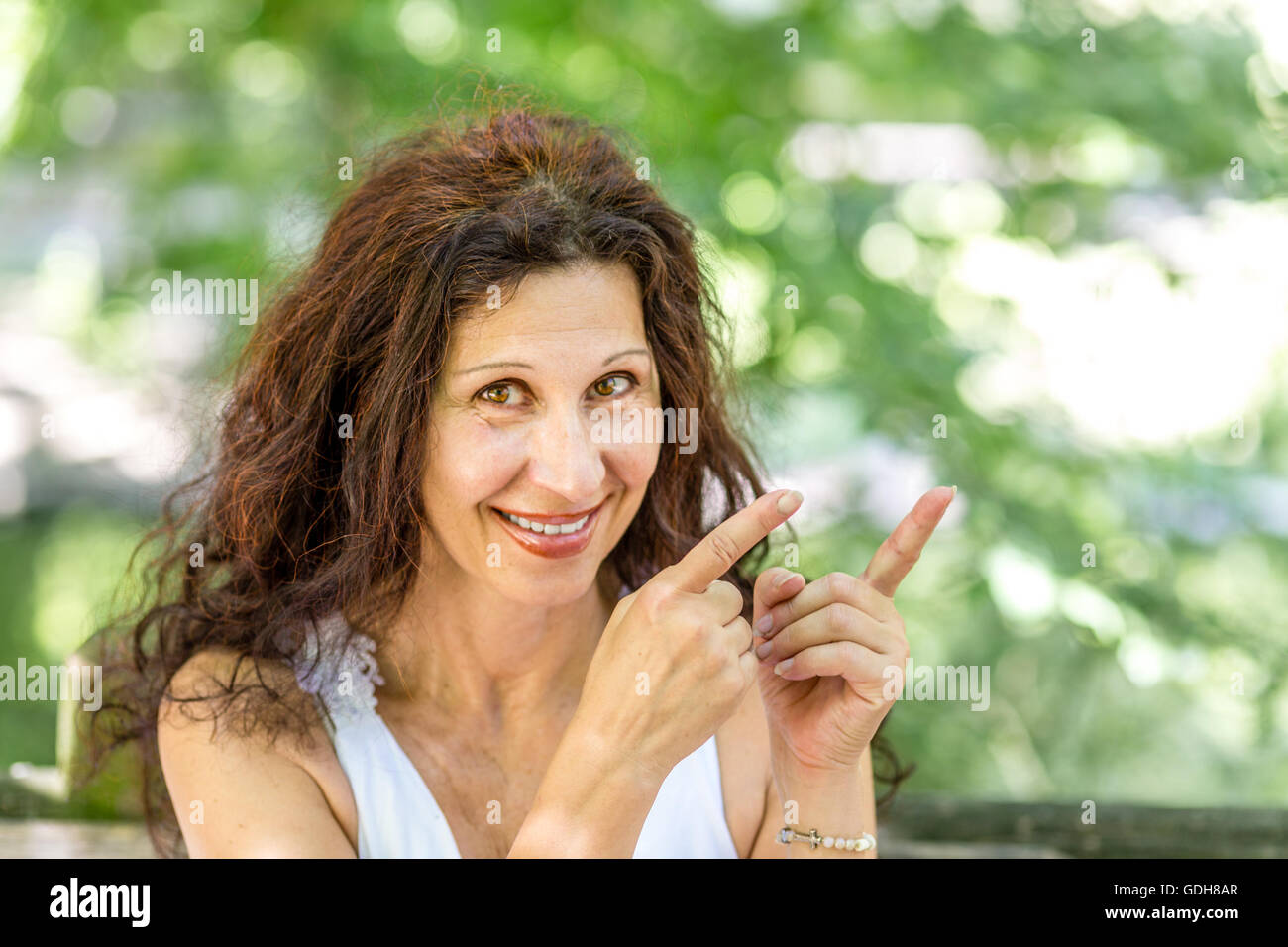 happy attractive woman pointing to the side with both hands Stock Photo ...