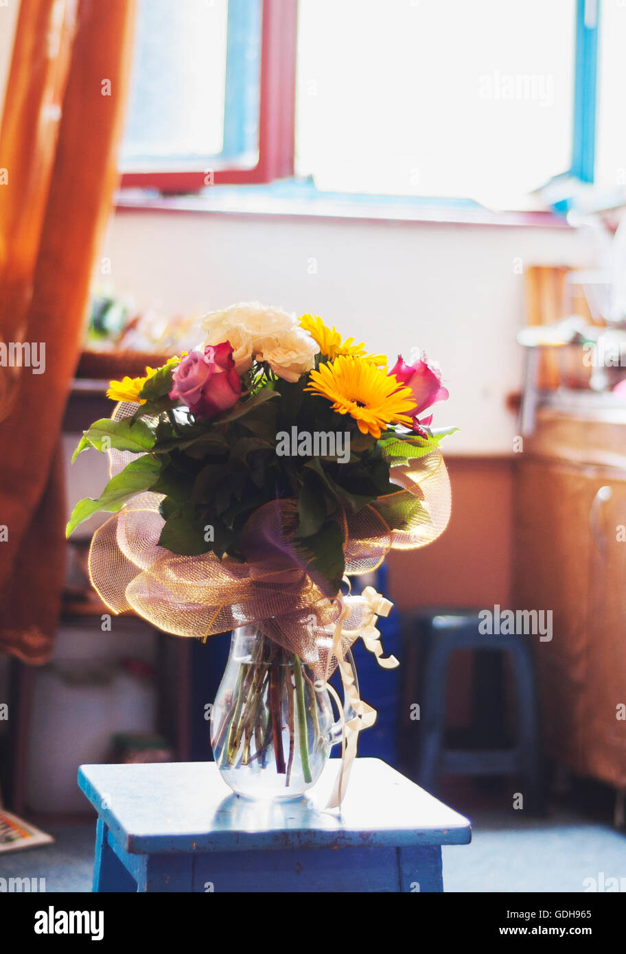 Bouquet of colorful flowers on a chair Stock Photo - Alamy
