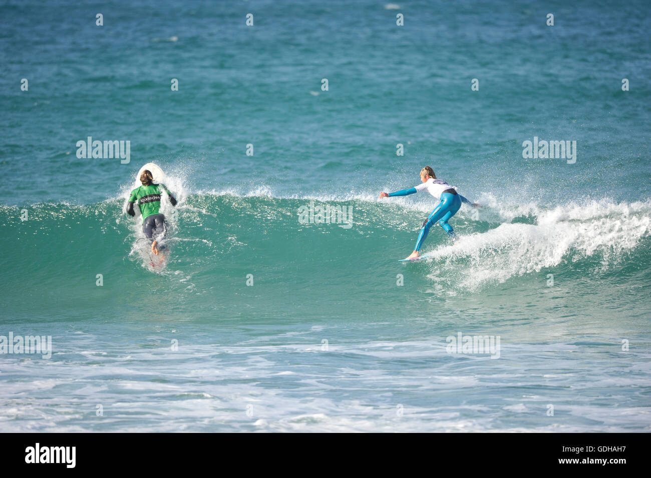 Two surfers riding a wave Stock Photo - Alamy Two surfers riding a wave Stock Photo - Alamy