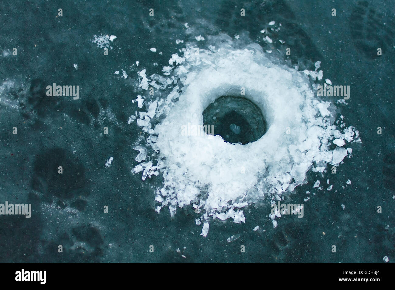 Hole in the ice of the lake Stock Photo - Alamy