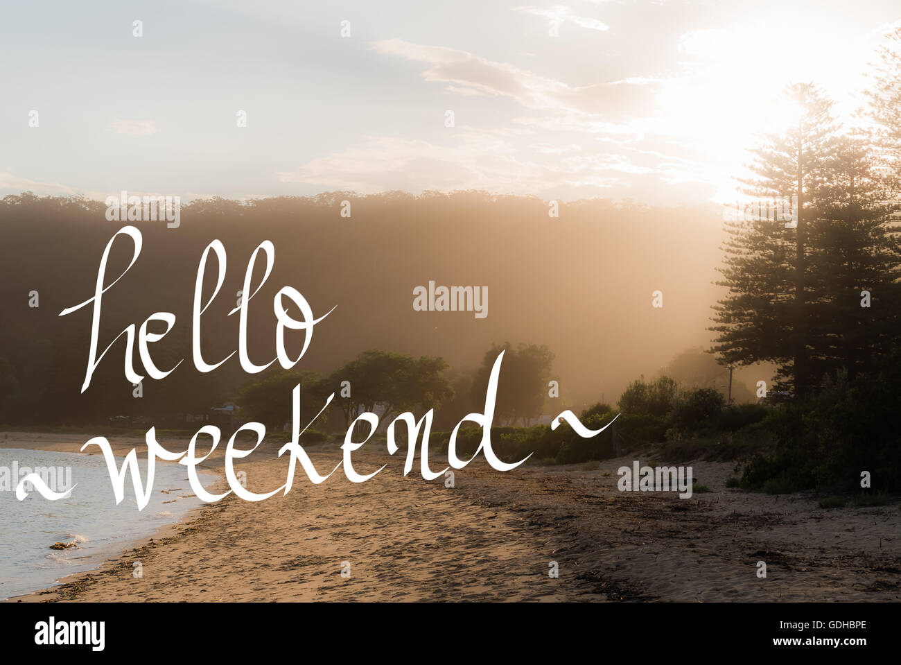 Hello Weekend Greeting. Handwritten motivational text over sunset calm ...