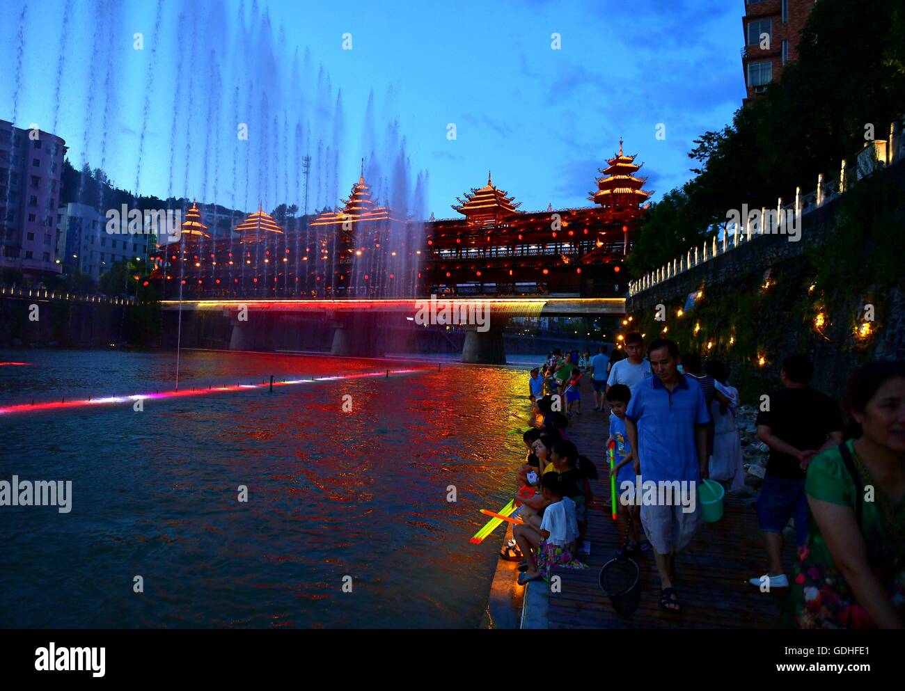 Enshi, China's Hubei Province. 16th July, 2016. People watch the music ...