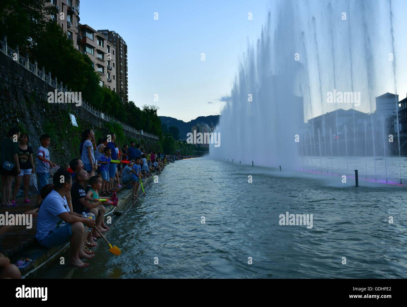 Enshi, China's Hubei Province. 16th July, 2016. People watch the music ...