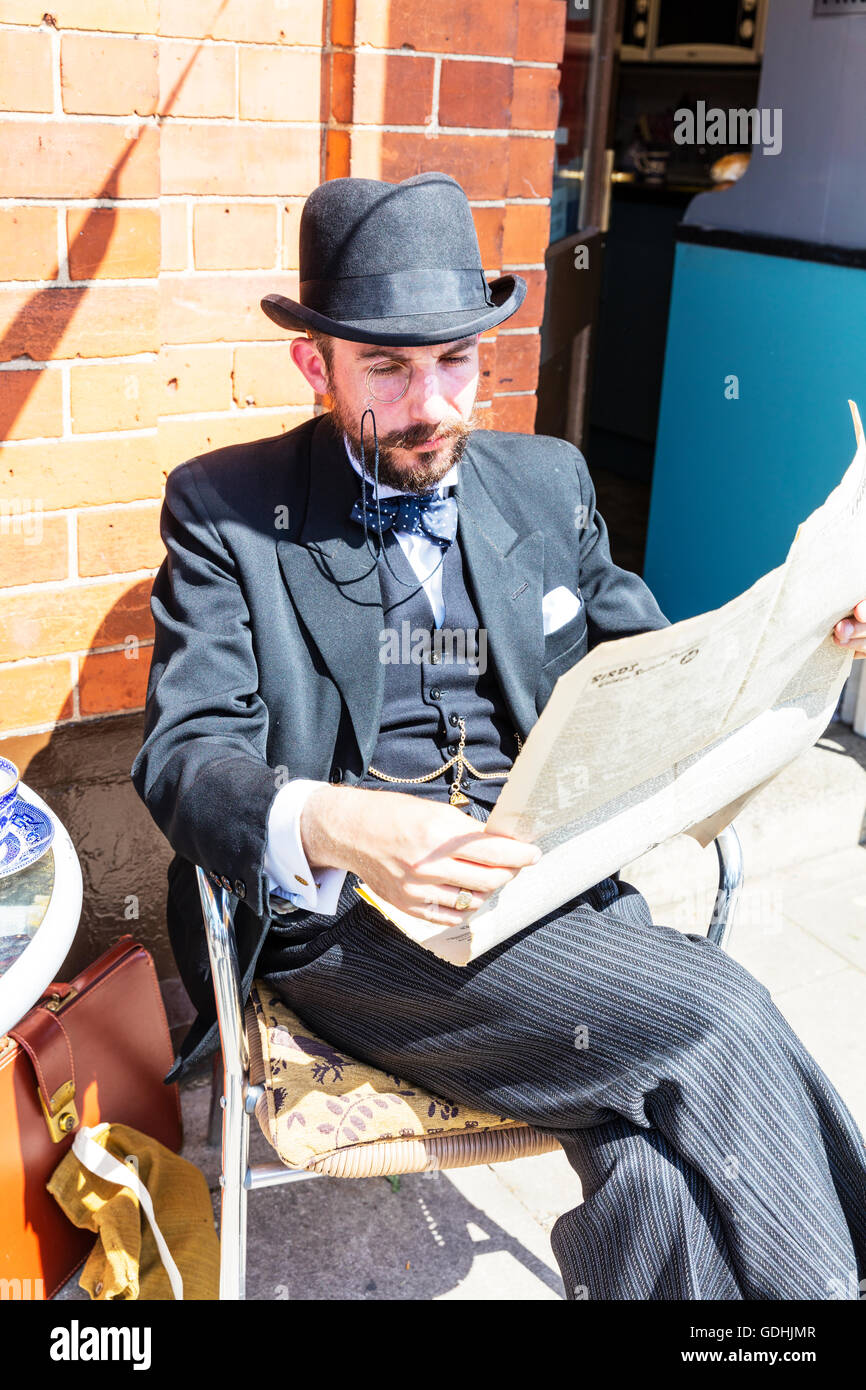 Well dressed man reading newspaper wearing monocle suit smart smartly ...