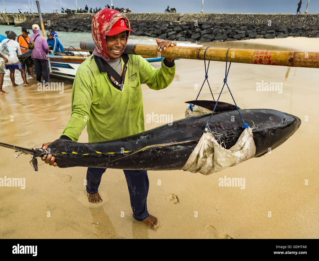 Kuta, Bali, Indonesia. 18th July, 2016. Workers carry yellowfin tuna to ...