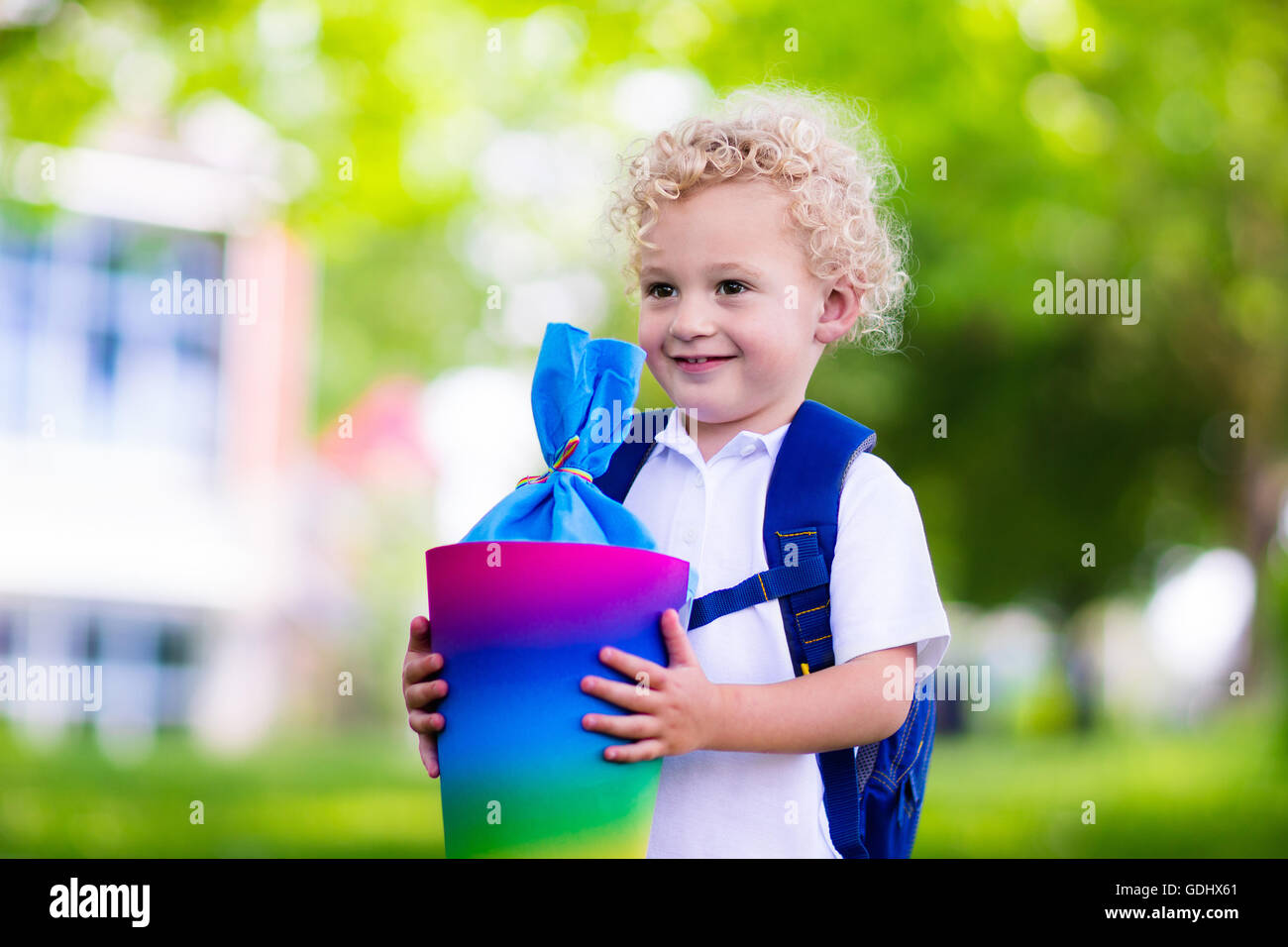 Child going to school. Kids holding traditional candy cone on first ...