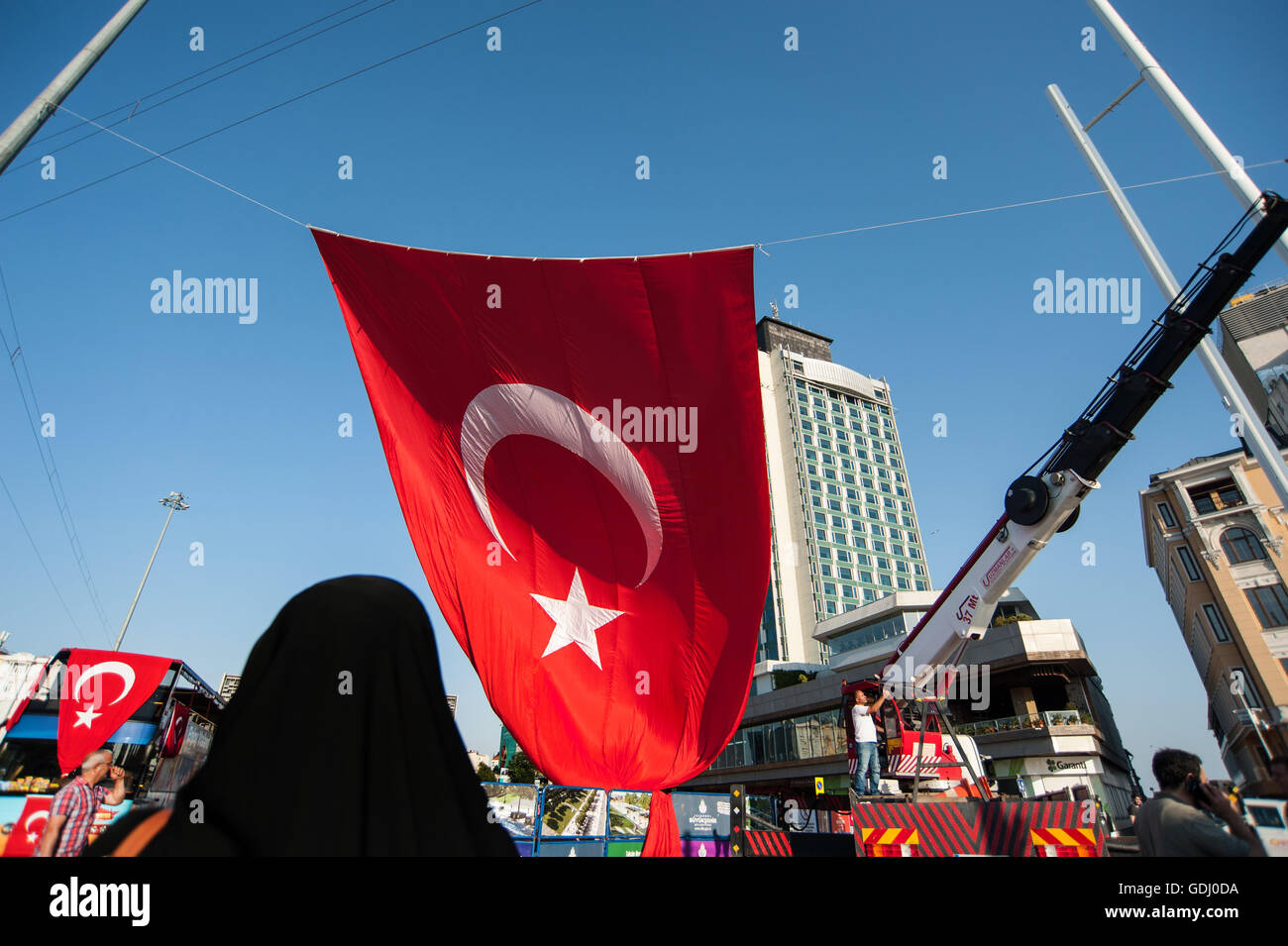 Giant Turkish flag being hung over Taksim Square ready for post ...