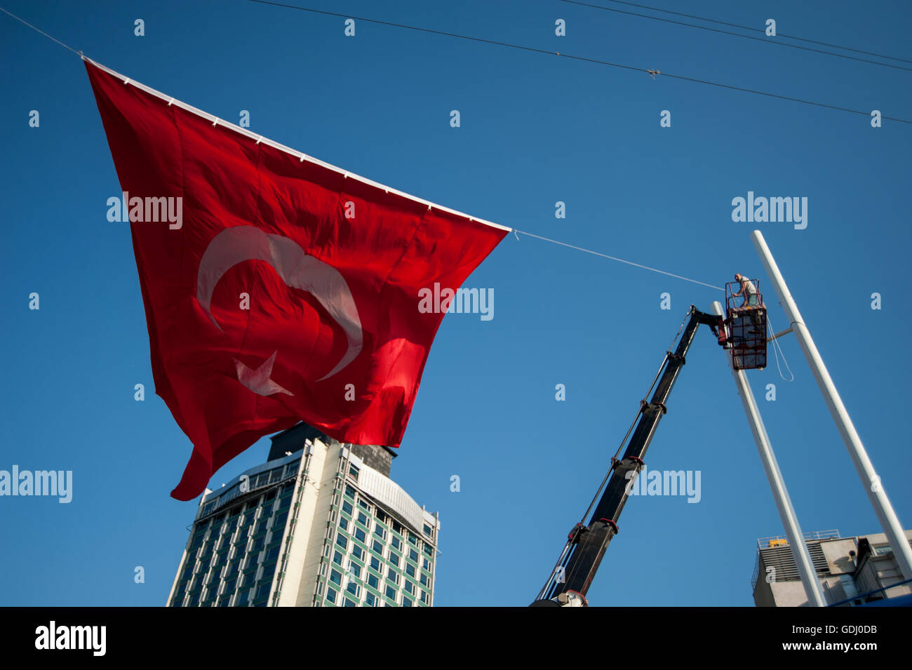 Giant Turkish flag being hung over Taksim Square ready for post ...