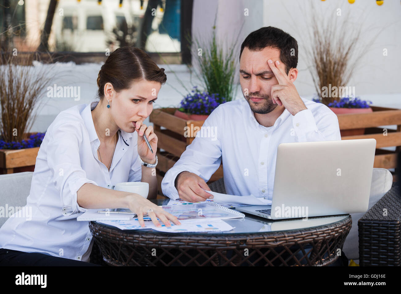 Male and female business colleagues working together on a hard problem ...