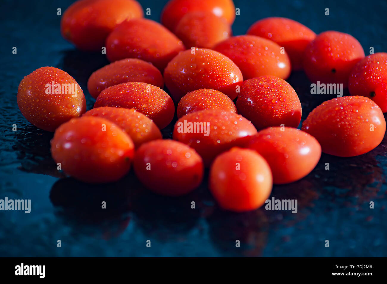 Red mini plum tomatoes hi-res stock photography and images - Alamy