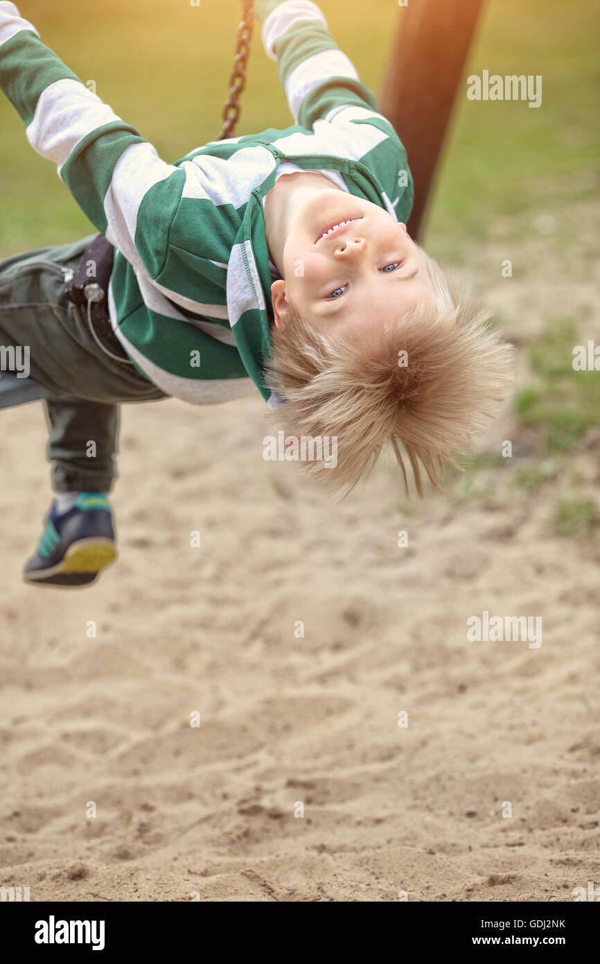 boy swings on a swing Stock Photo - Alamy