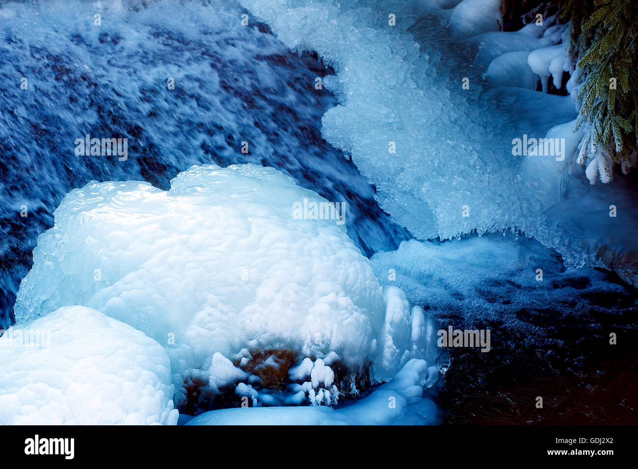 Winter scene with water falling from icy rocks Stock Photo - Alamy