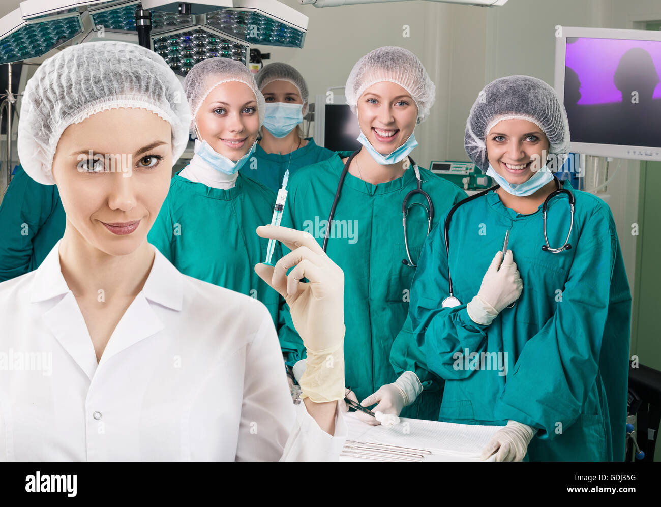 Young female anesthetist with syringe on the surgery teem background ...
