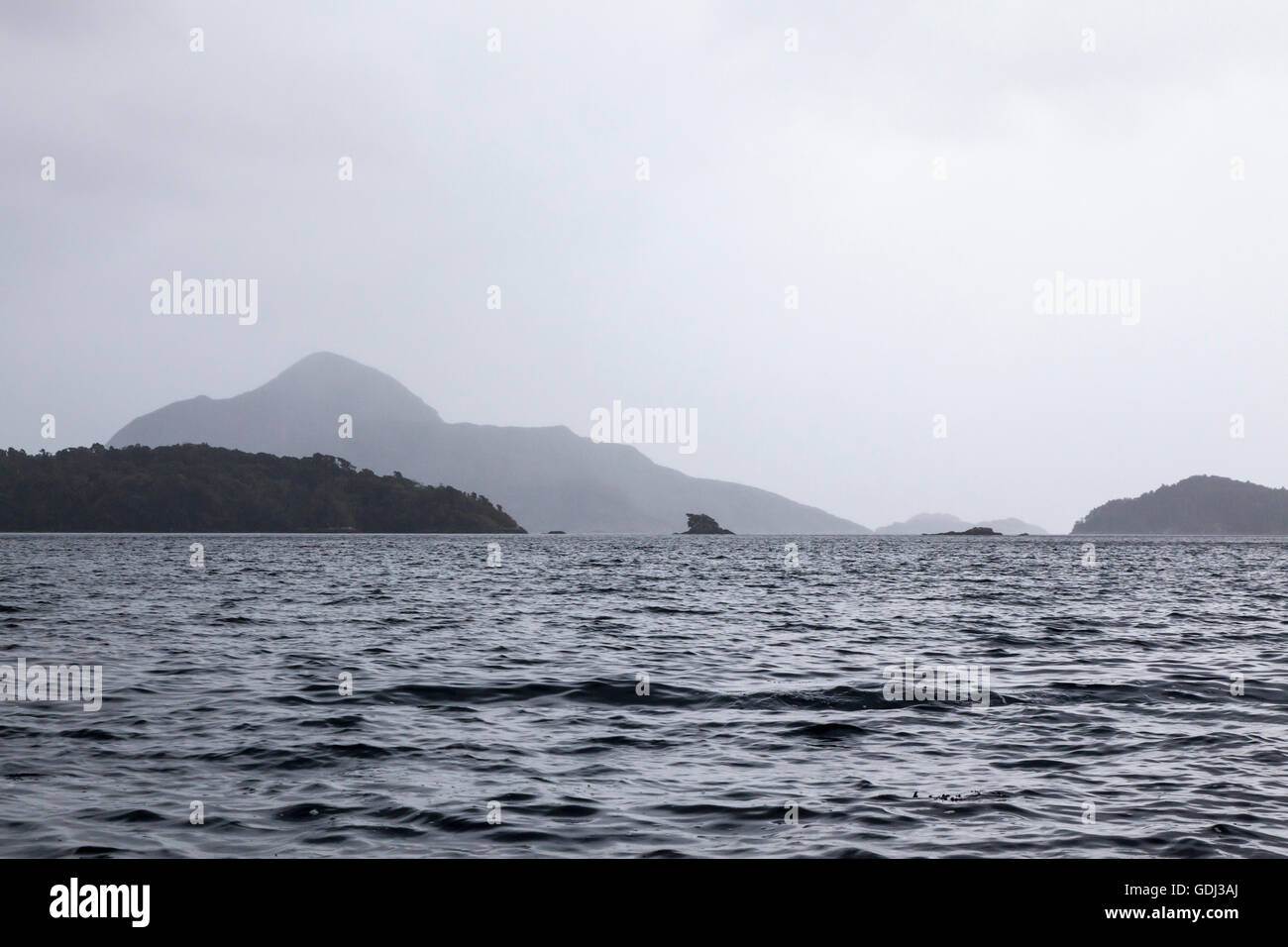 Dusky Sound in overcast conditions, Fiordland, New Zealand Stock Photo ...