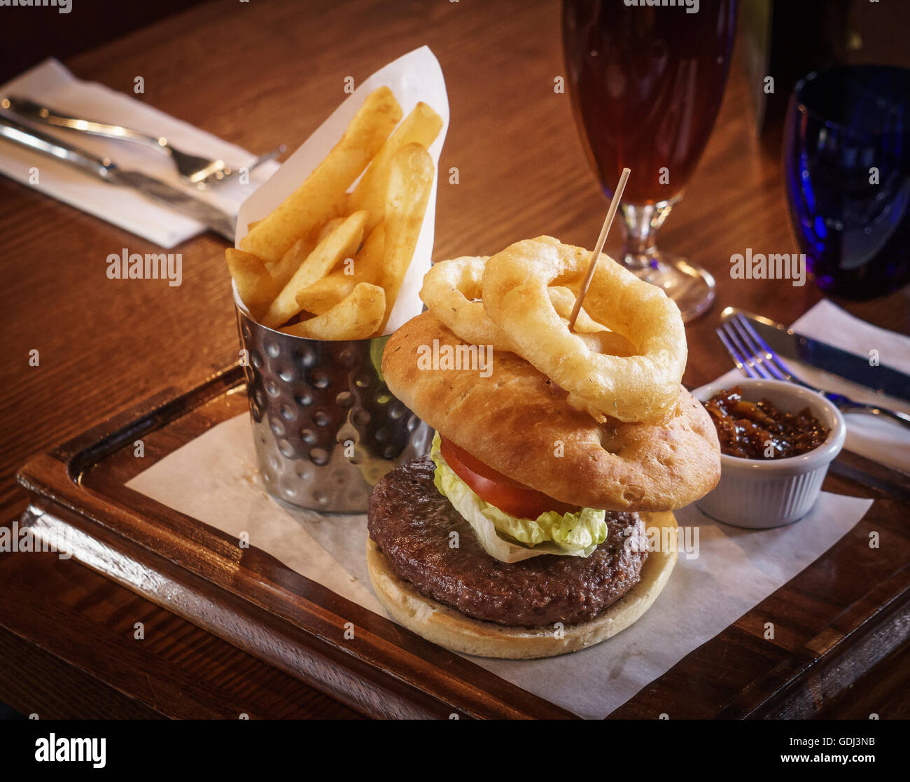 Fresh Scottish burger with onion rings and garnish Stock Photo - Alamy