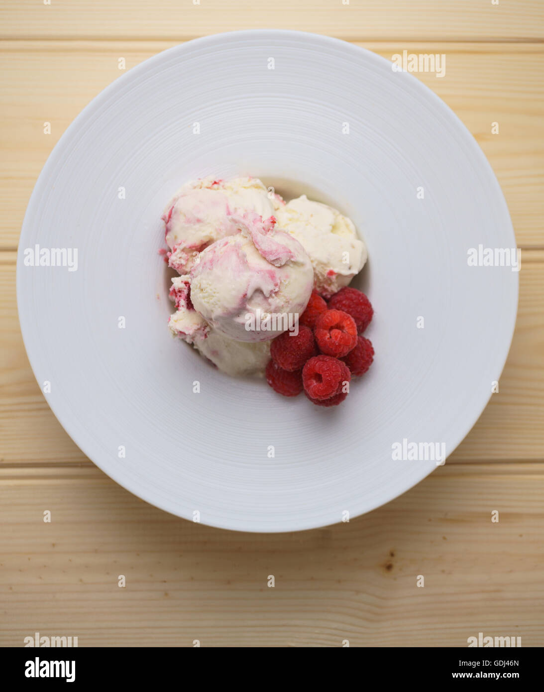 Raspberry ripple ice cream, served with fresh raspberries Stock Photo ...