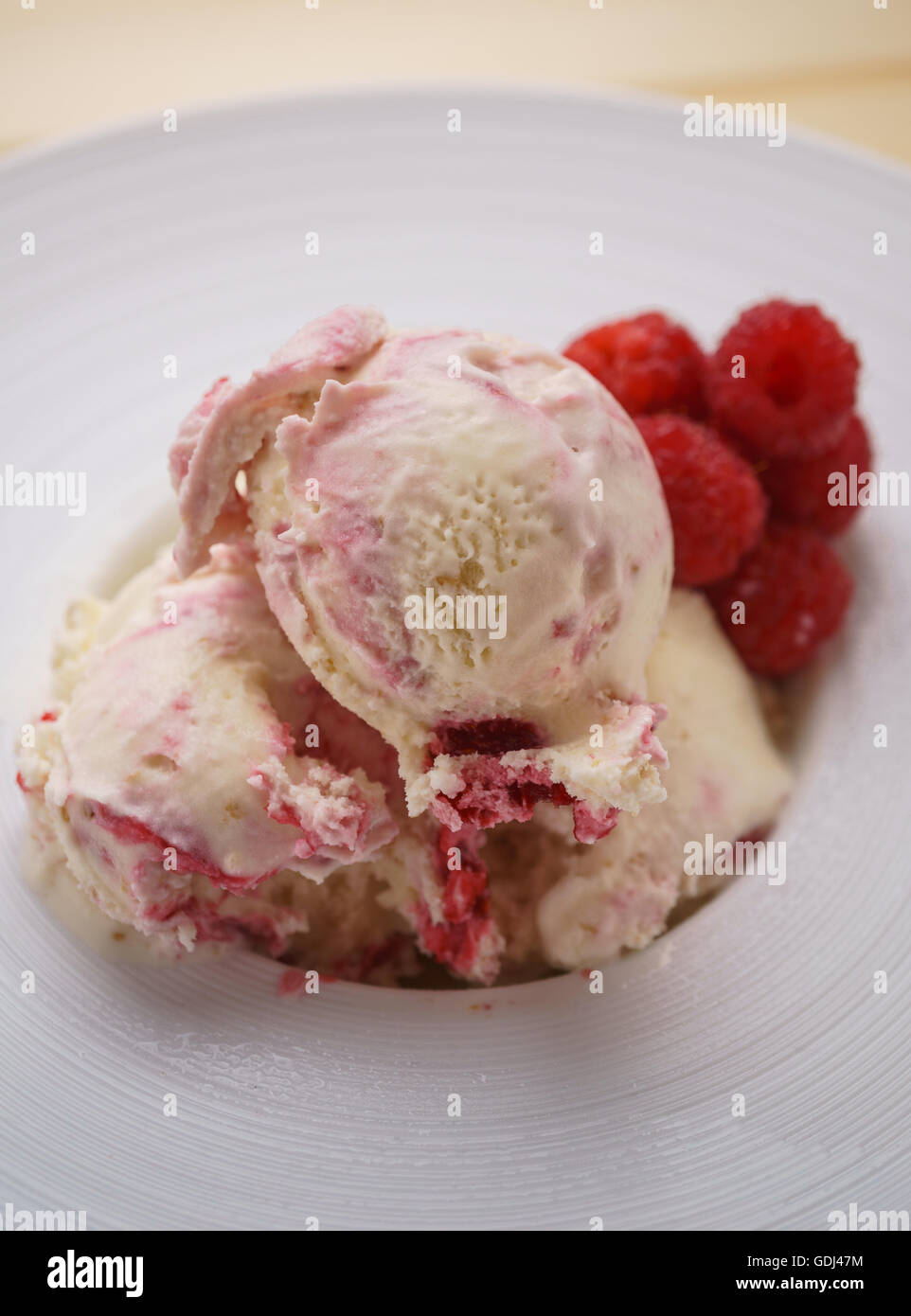 Raspberry ripple ice cream, served with fresh raspberries Stock Photo ...