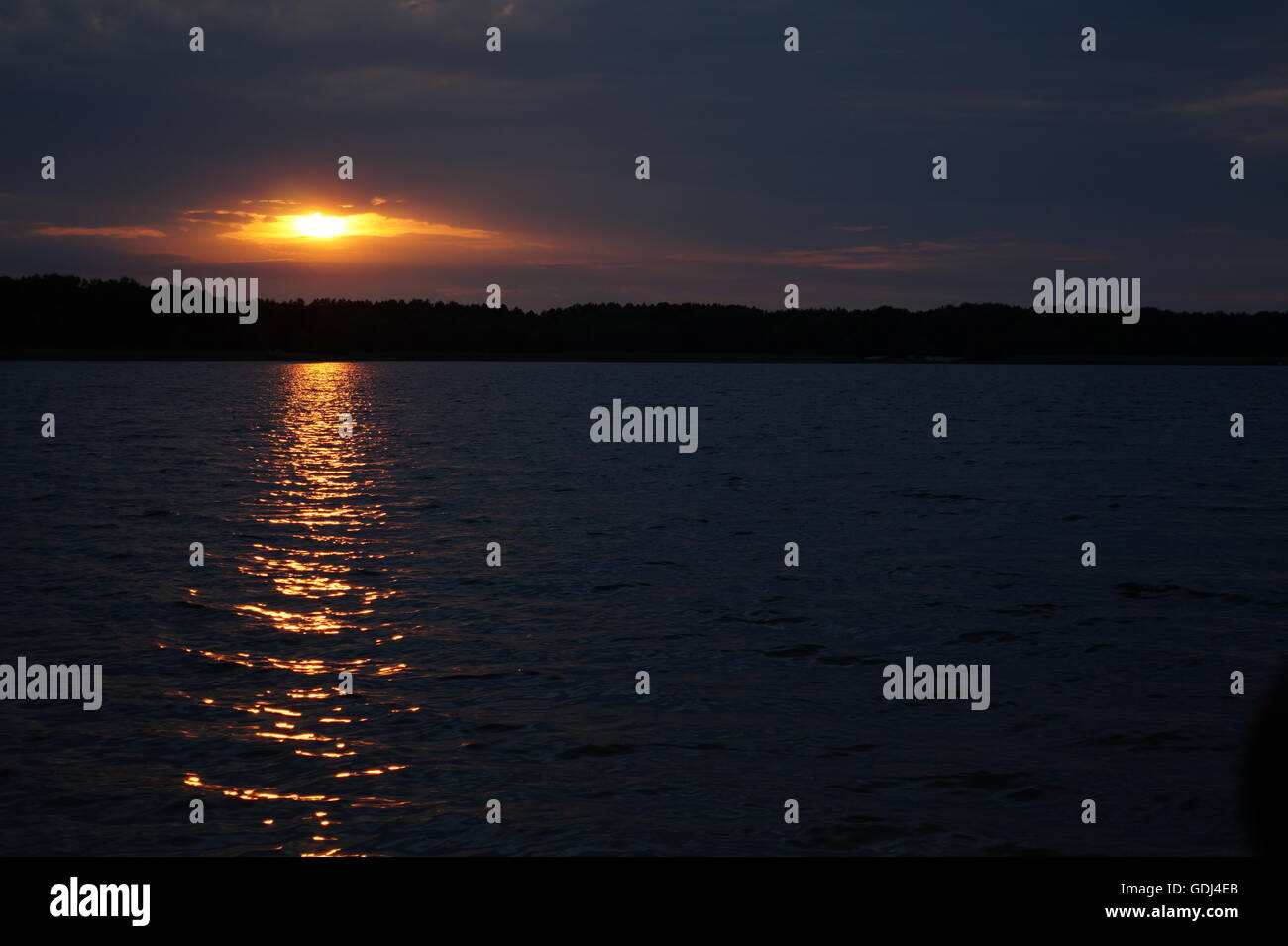 A time lapse of the large orange sunset as the massive sun sets into ...