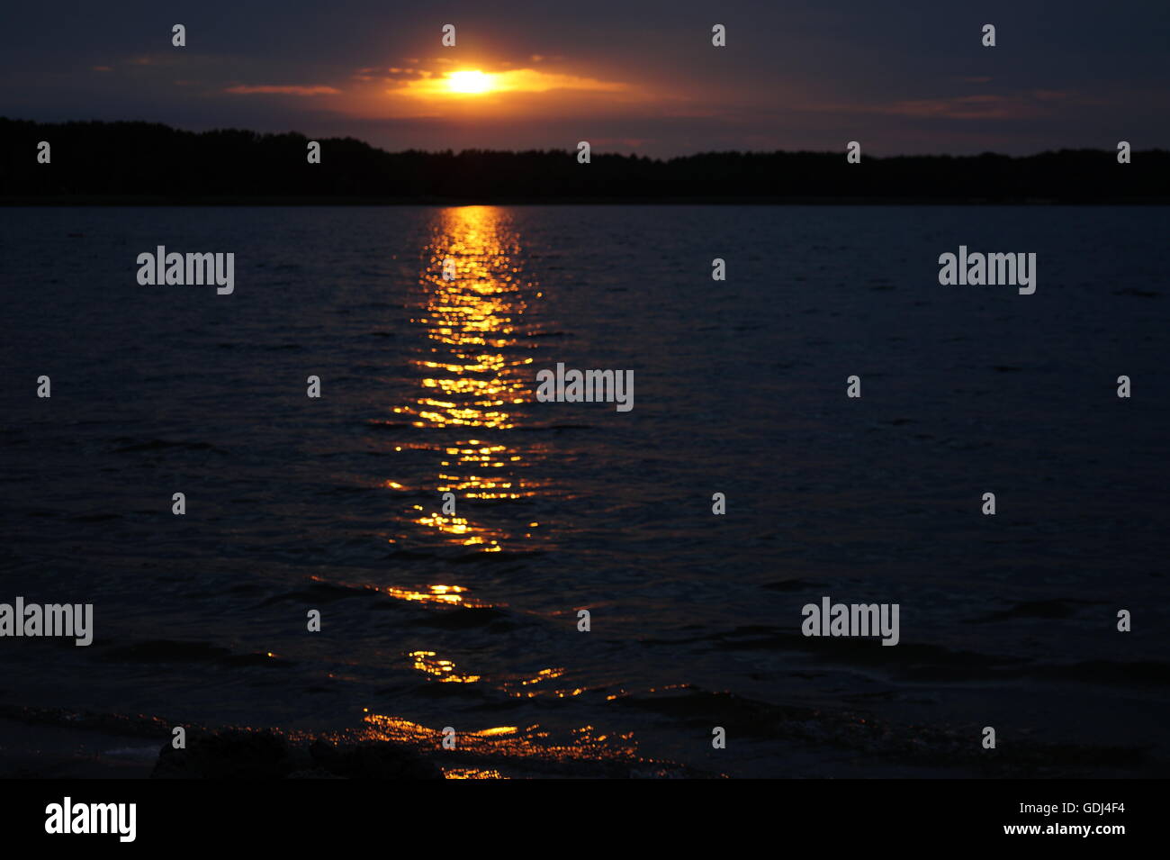 A time lapse of the large orange sunset as the massive sun sets into ...