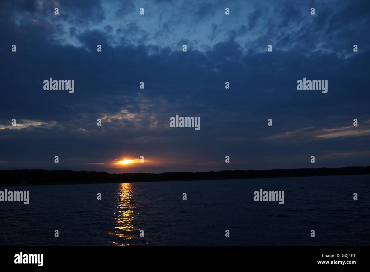 A time lapse of the large orange sunset as the massive sun sets into ...
