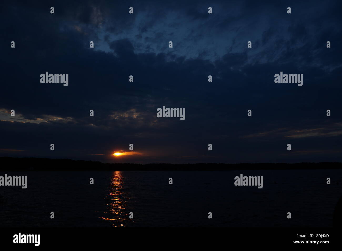 A time lapse of the large orange sunset as the massive sun sets into ...