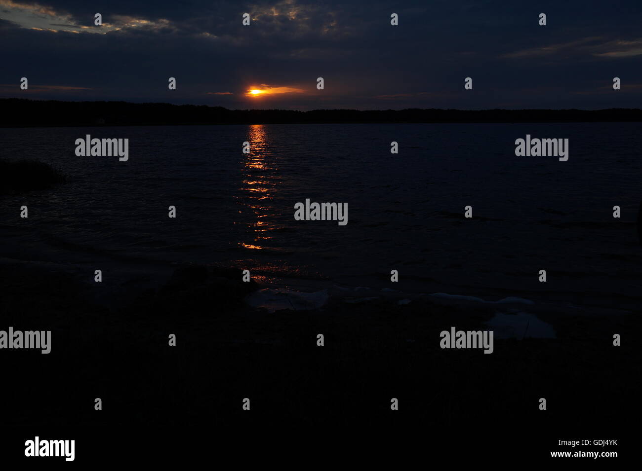 A time lapse of the large orange sunset as the massive sun sets into ...