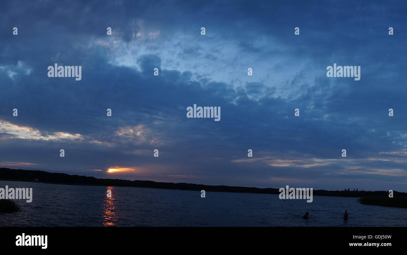 A time lapse of the large orange sunset as the massive sun sets into ...
