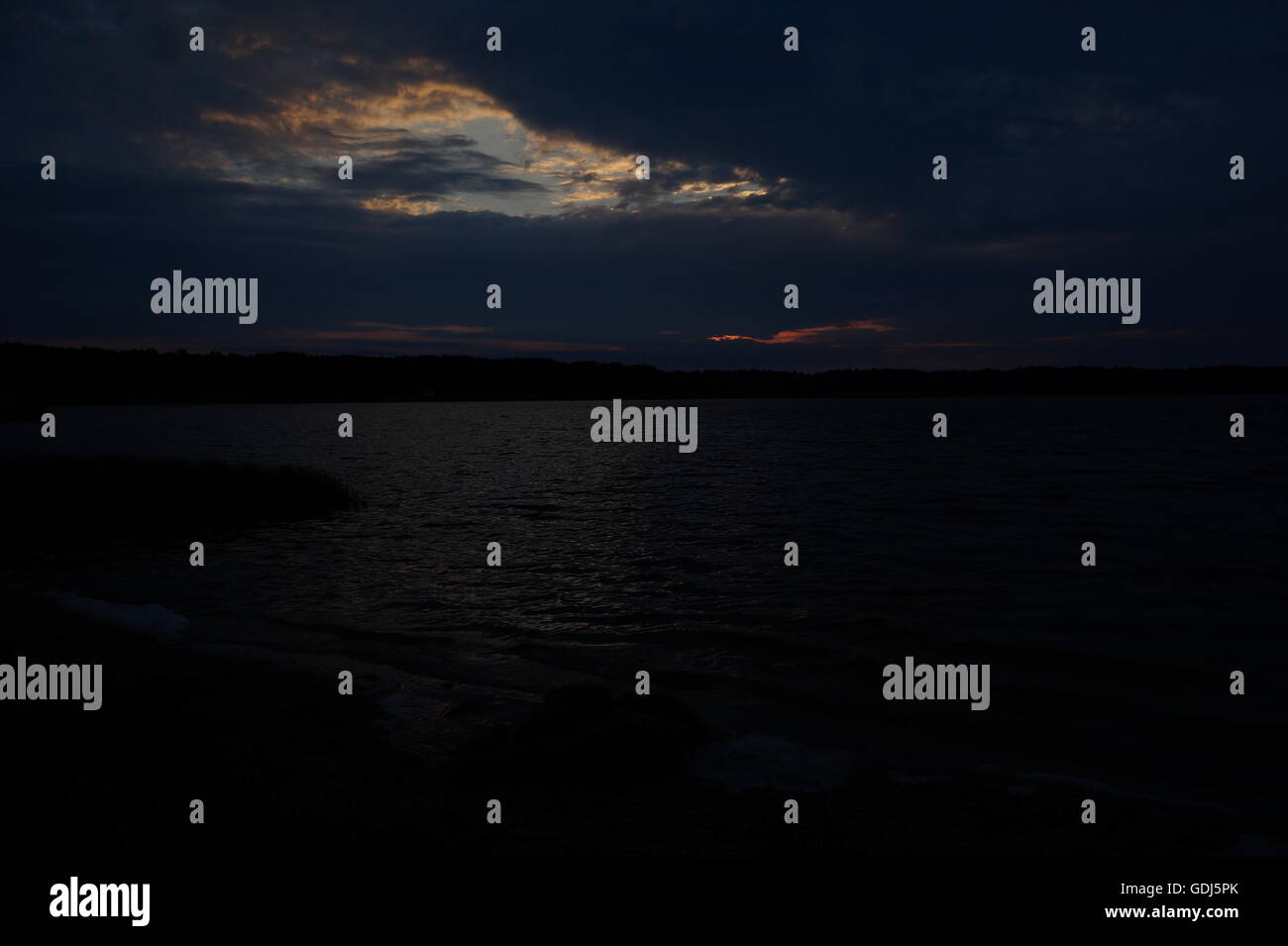 A time lapse of the large orange sunset as the massive sun sets into ...