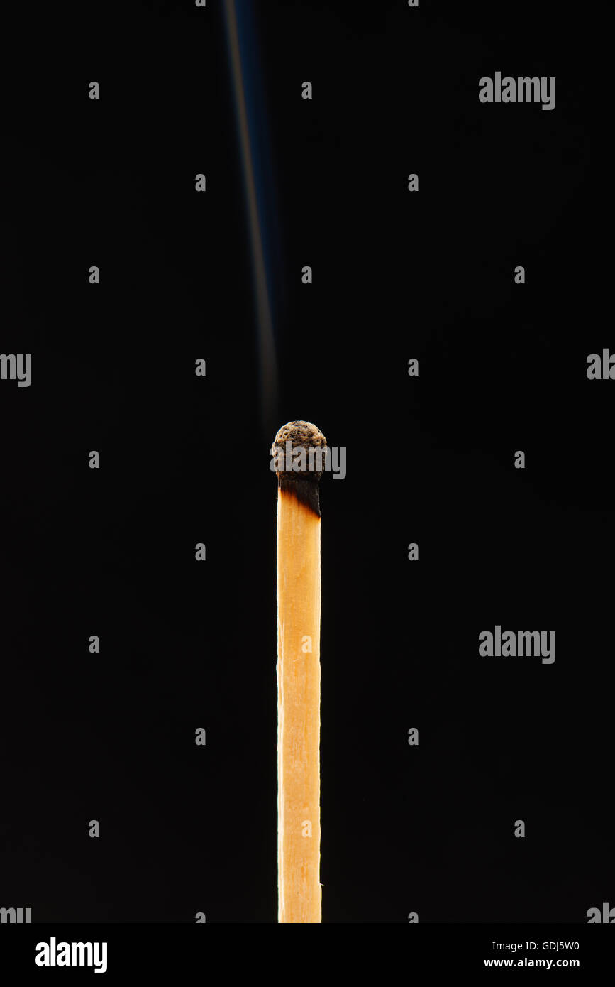 Burnt match with smoke isolated on black background Stock Photo - Alamy