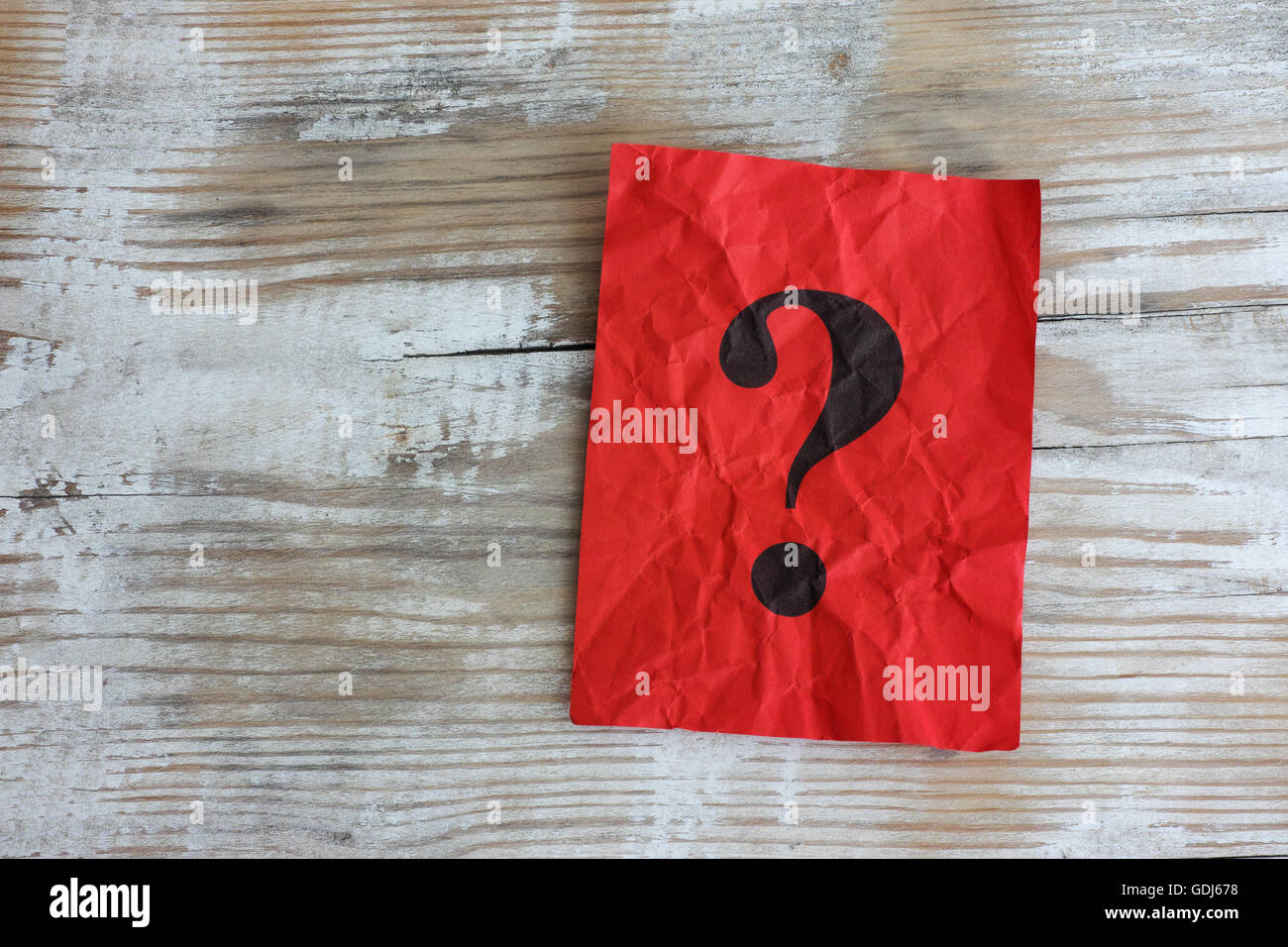 Red paper note with question marks on wooden background. Close up Stock ...