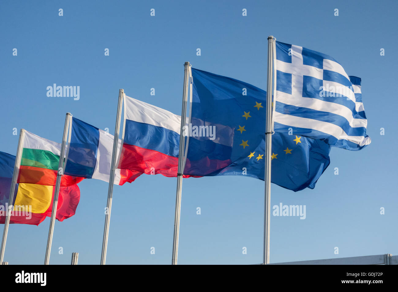 Flags of different countries are developing on the flagpoles Stock ...