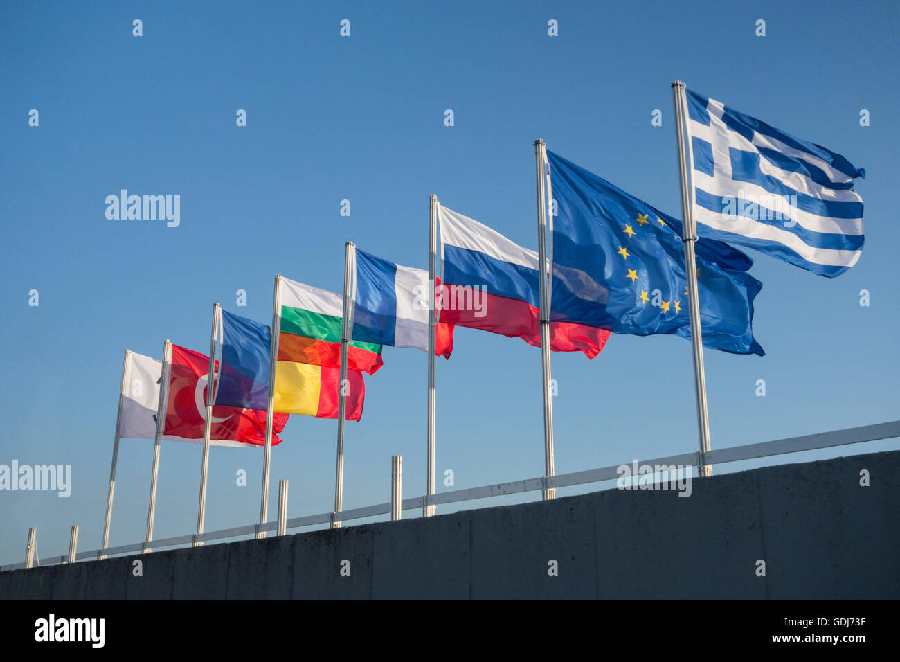 Flags of different countries are developing on the flagpoles Stock ...