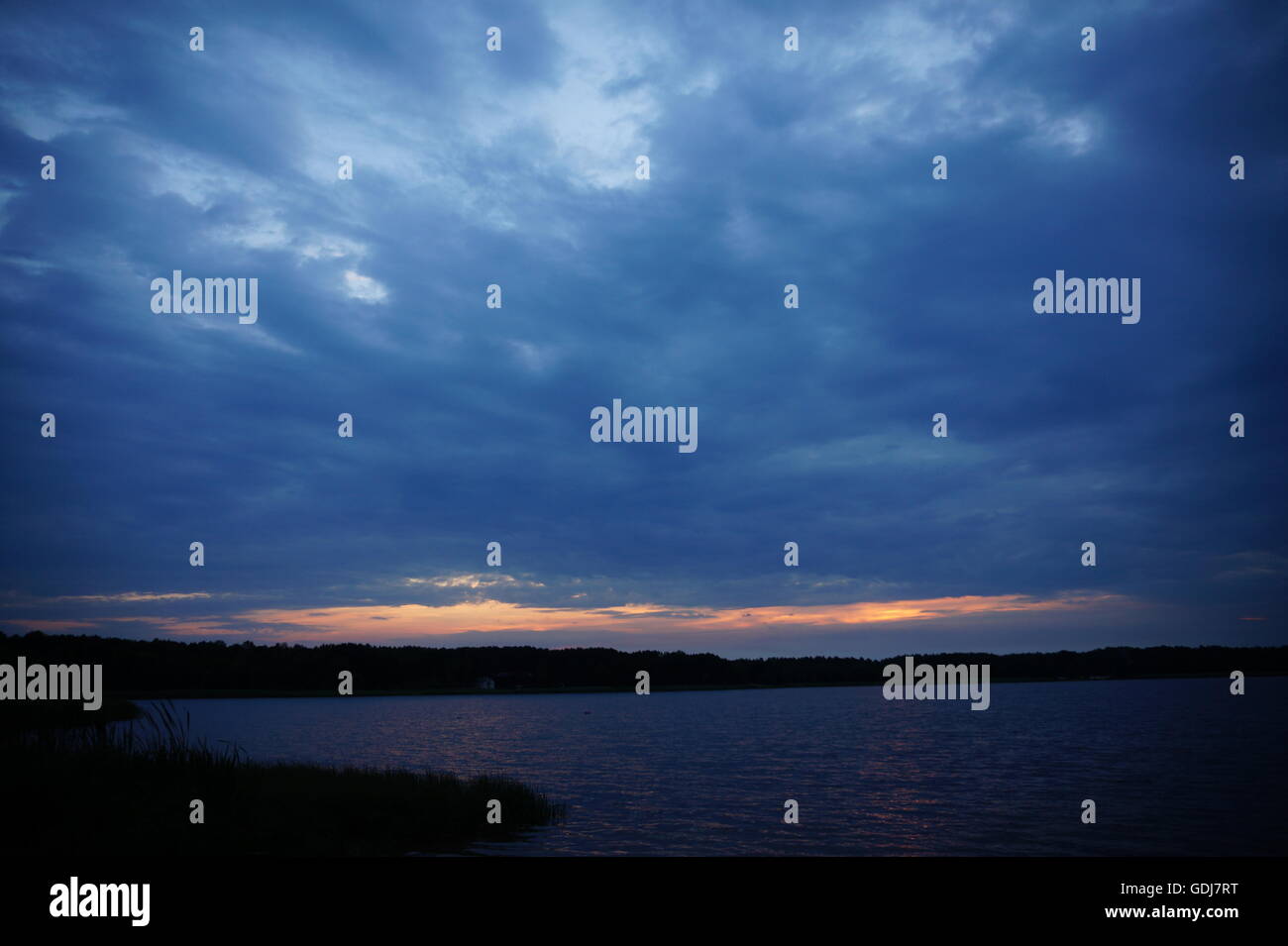 A time lapse of the large orange sunset as the massive sun sets into ...