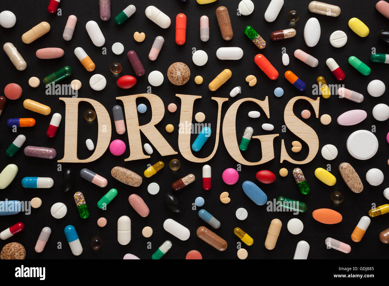 Word DRUGS with wooden letters surrounded by colorful pills Stock Photo ...