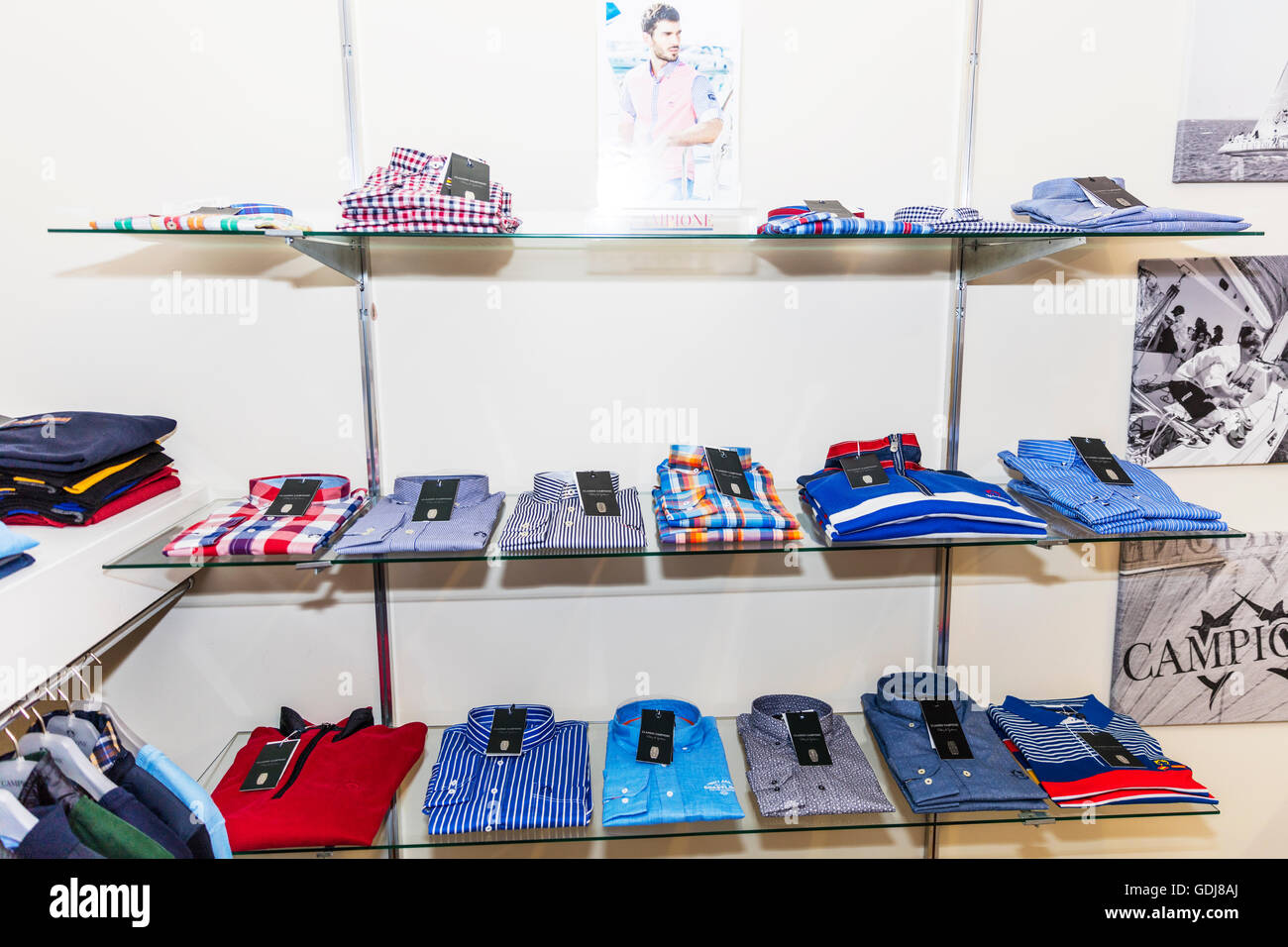 Shirts on shelf in clothes shop display displaying shirts for men to ...