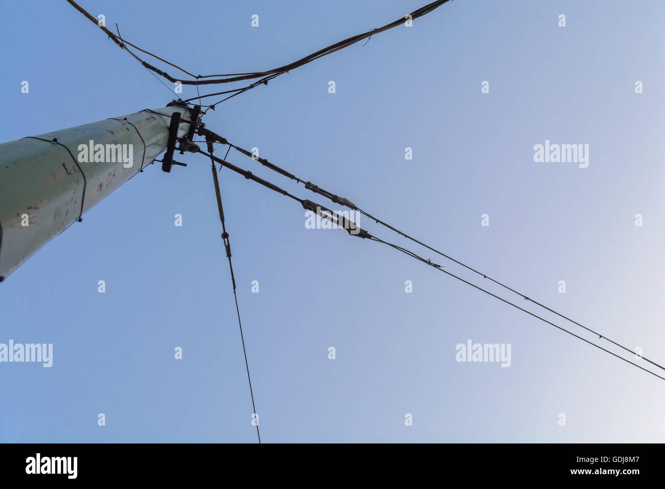 pole with wires attached to it intersect at different angles against ...