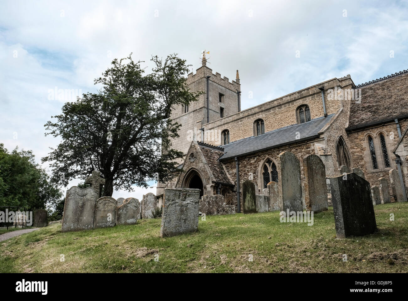 Typically designed English church seen with a small cemetery in the ...