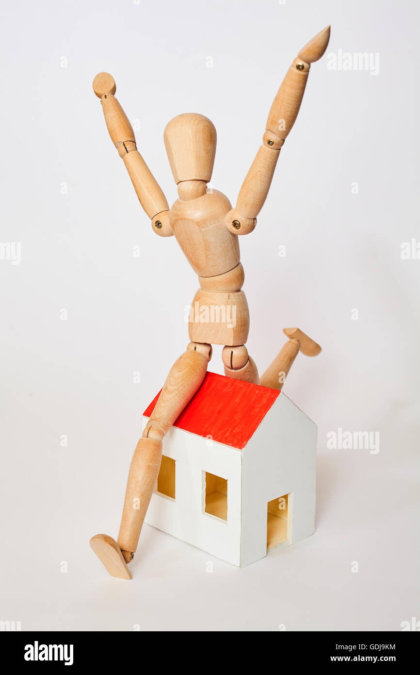 Dummy feeling happy with small house on white background Stock Photo ...